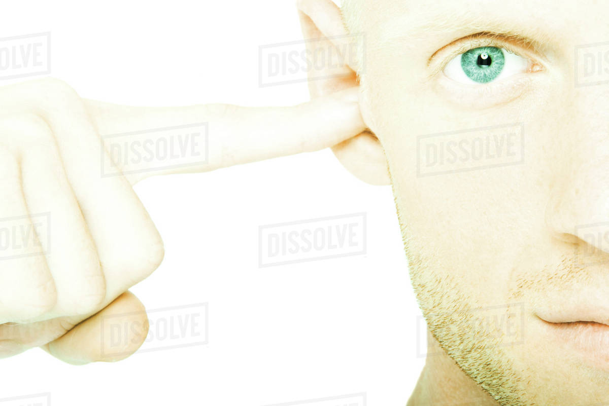 Young man plugging ear with finger - Royalty-free Stock Photo | Dissolve