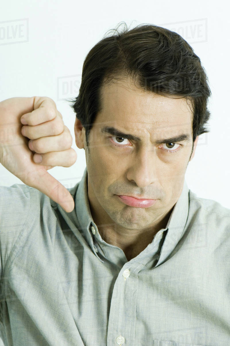 Man giving thumbs down sign, portrait - Stock Photo - Dissolve