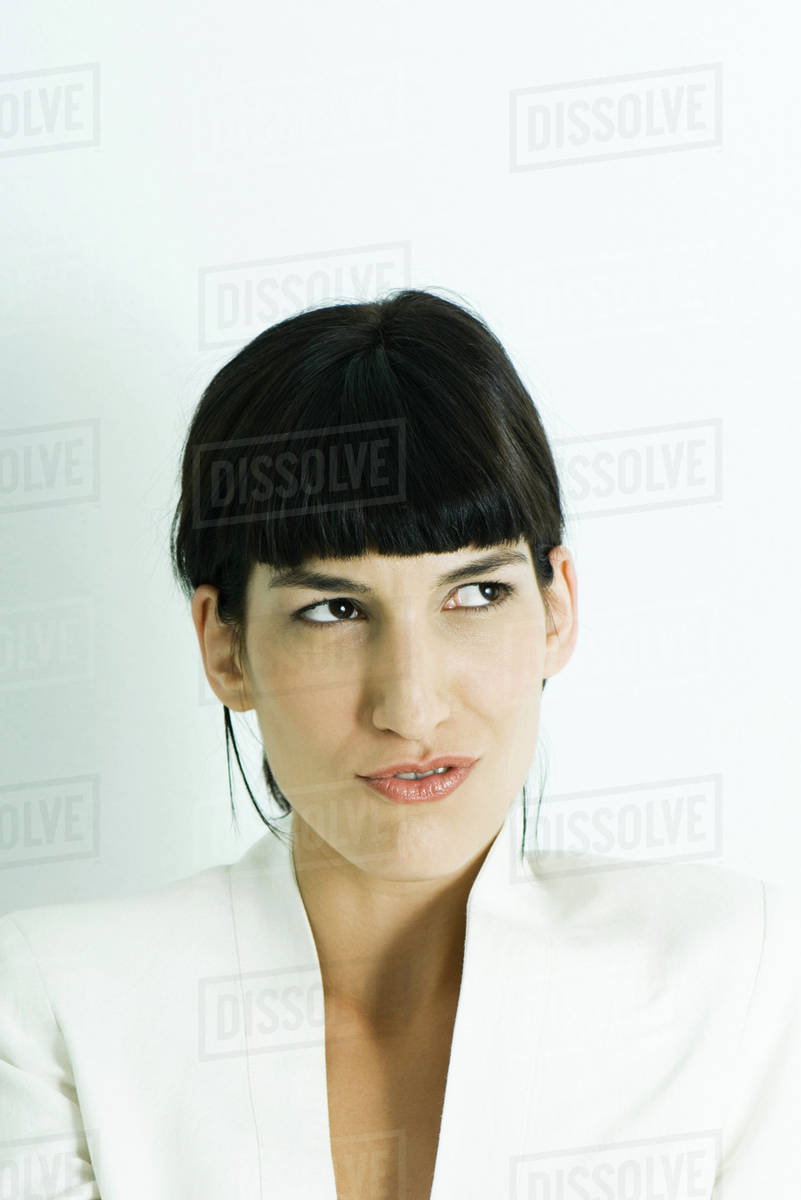 Woman giving sideways look, portrait - Stock Photo - Dissolve