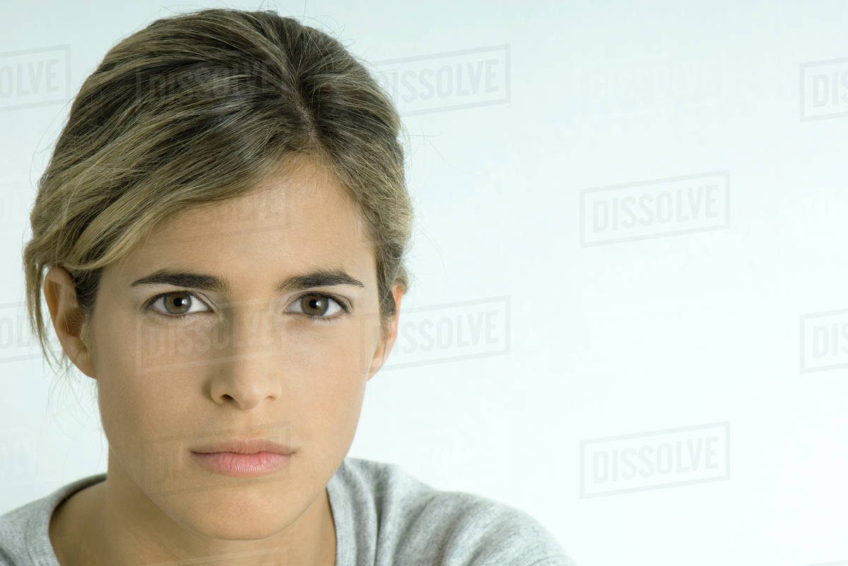 Woman glaring at camera, portrait - Stock Photo - Dissolve