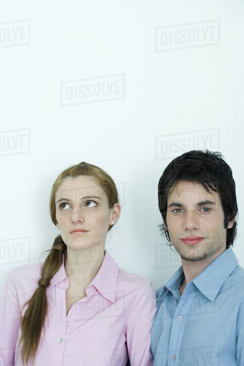 Young couple, man looking at camera while woman looks away, portrait ...