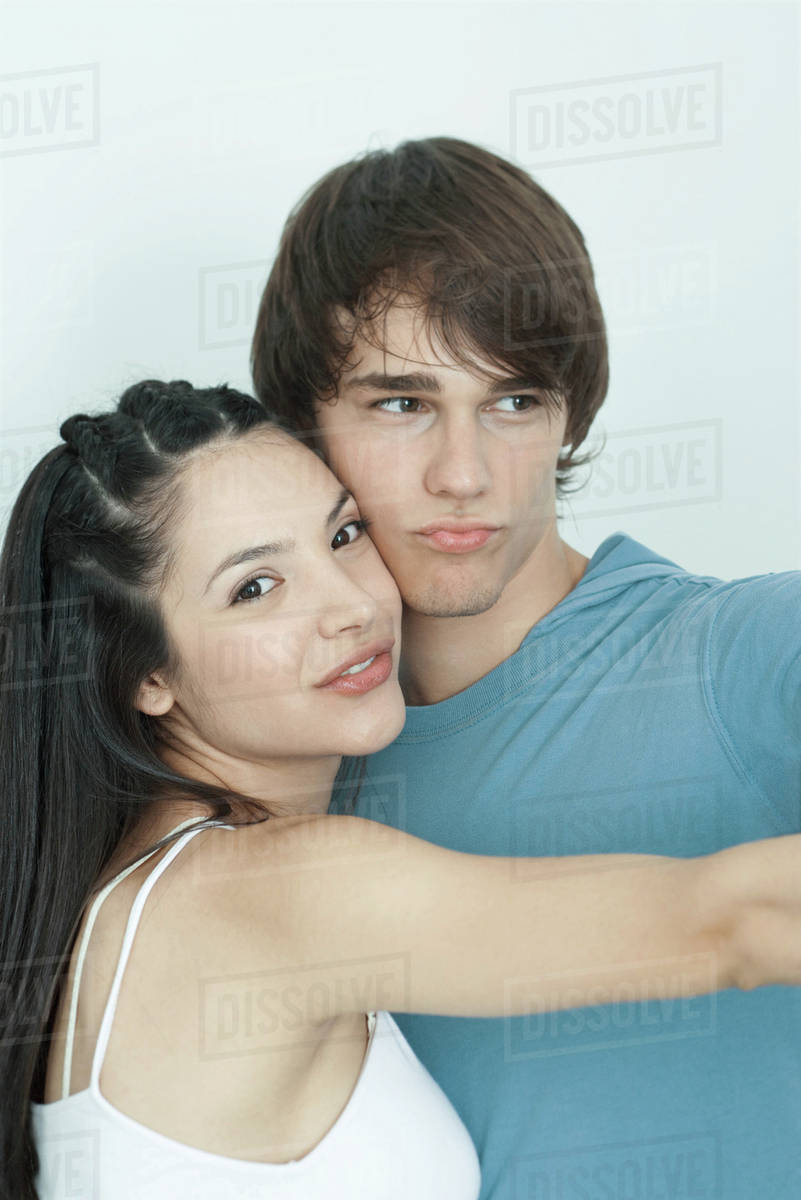 Young couple with cheeks together and arms out, portrait - Royalty-free ...