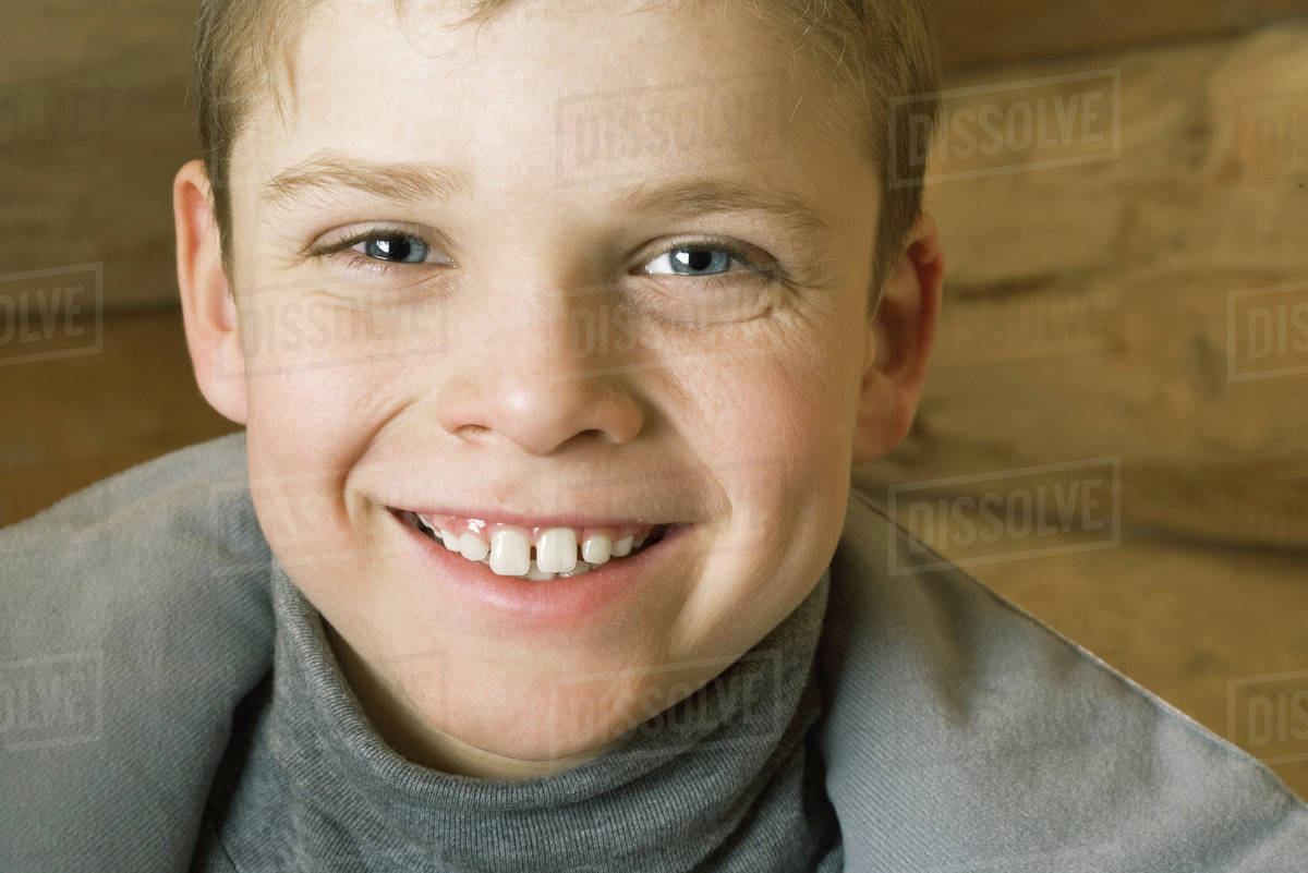 Boy smiling at camera, portrait - Stock Photo - Dissolve