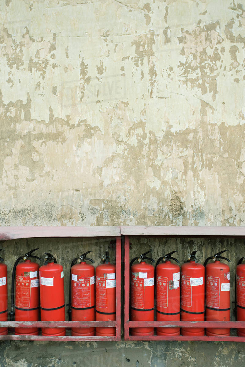 Row of fire extinguishers - Stock Photo - Dissolve