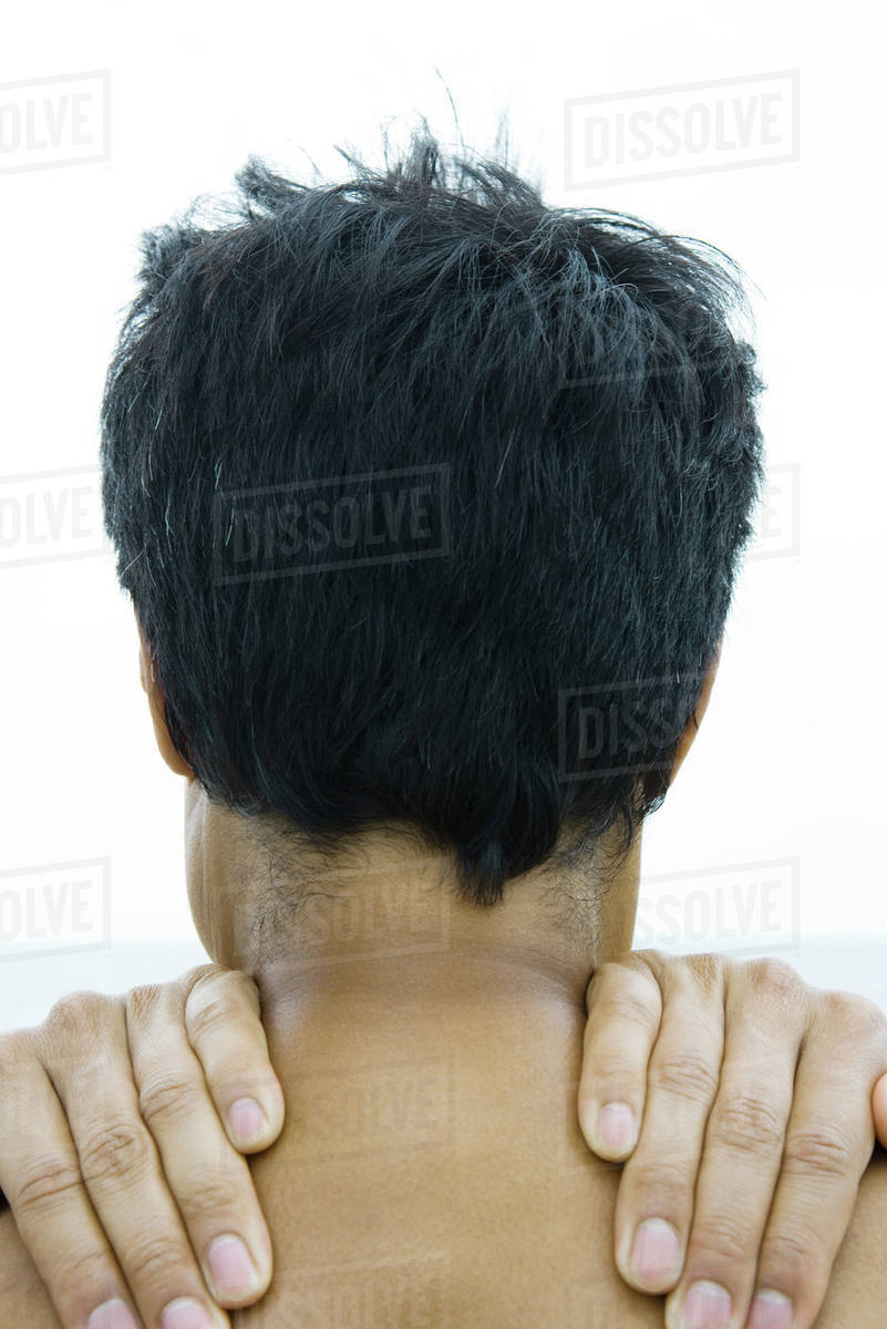 Man with hands on shoulders, cropped rear view - Stock Photo - Dissolve