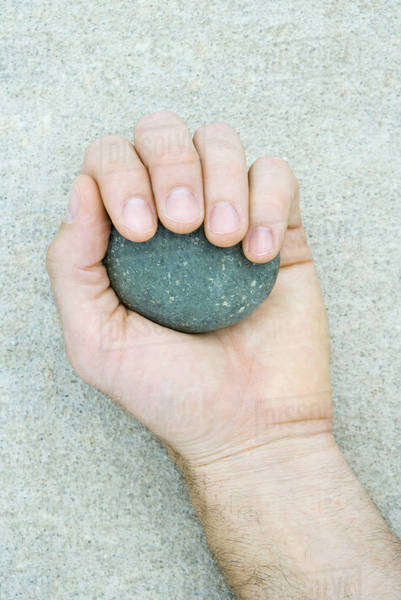 Man holding pebble in hand, cropped view - Royalty-free Stock Photo ...