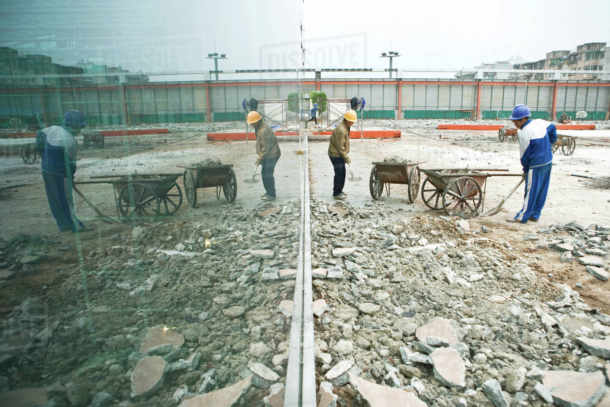 Two construction workers digging on construction site - Royalty-free ...