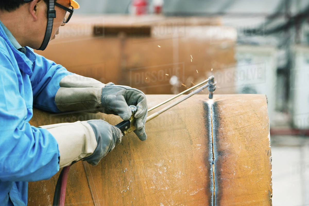 Man cutting metal with welding torch, side view, cropped - Royalty-free ...