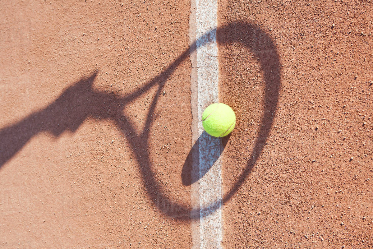 Shadow of tennis racket over tennis ball - Royalty-free Stock Photo ...