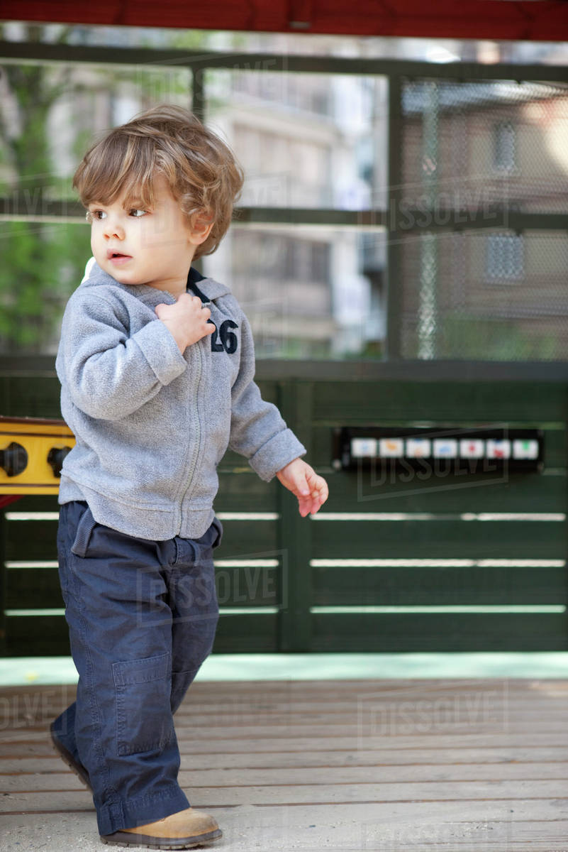 Little boy walking on playground - Royalty-free Stock Photo | Dissolve