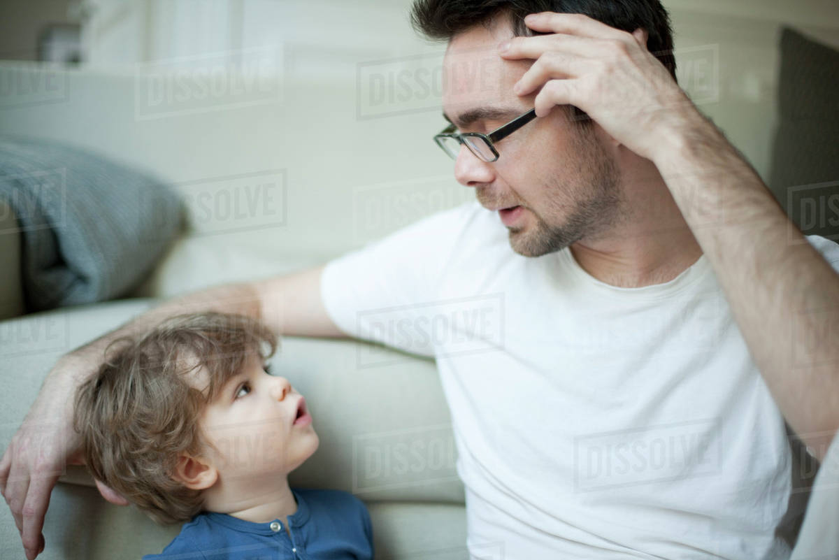 Father talking to young son, portrait - Royalty-free Stock Photo | Dissolve