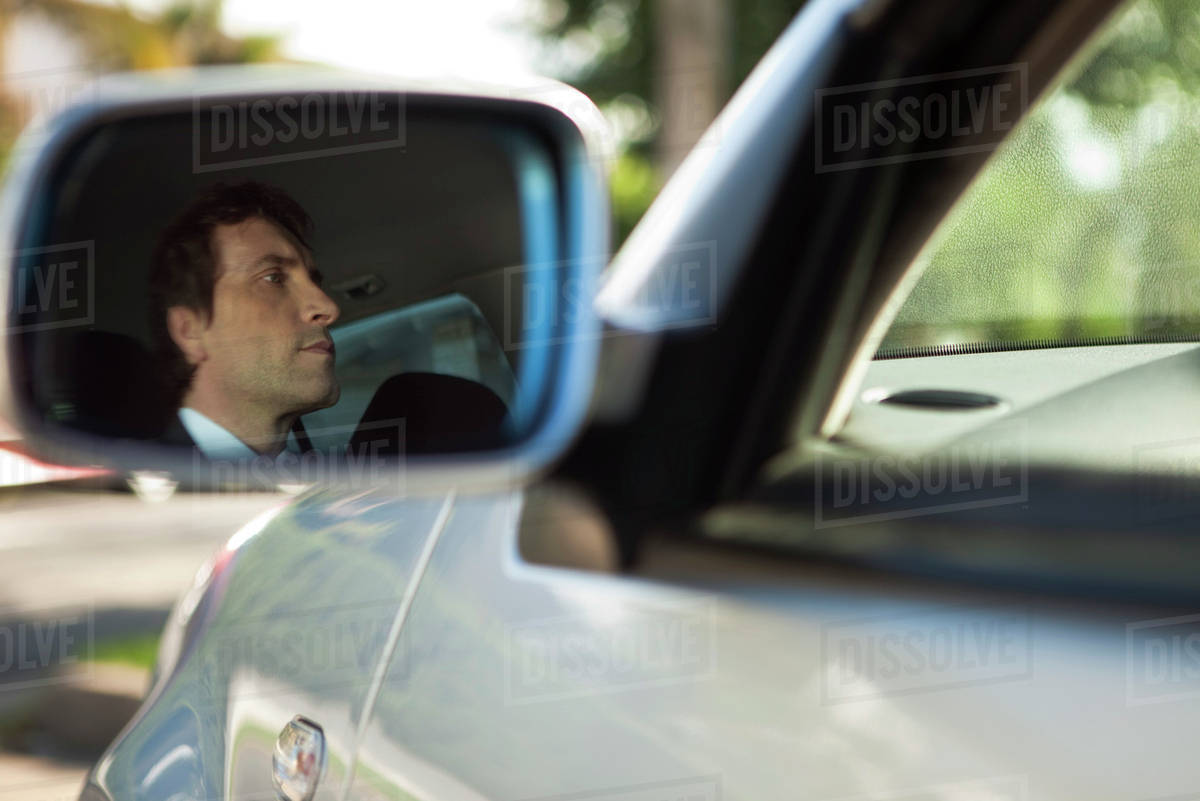 Reflection of car driver seen in side-view mirror - Royalty-free Stock ...