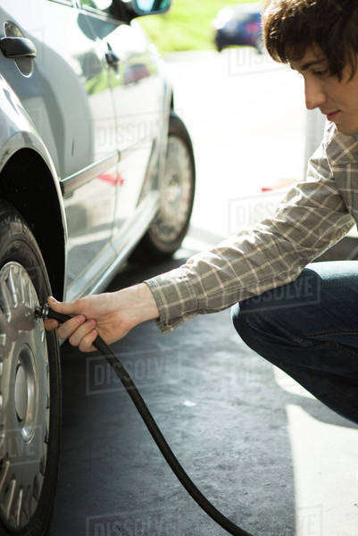 Inflating car tire - Stock Photo - Dissolve
