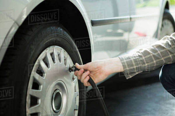 Inflating car tire - Stock Photo - Dissolve