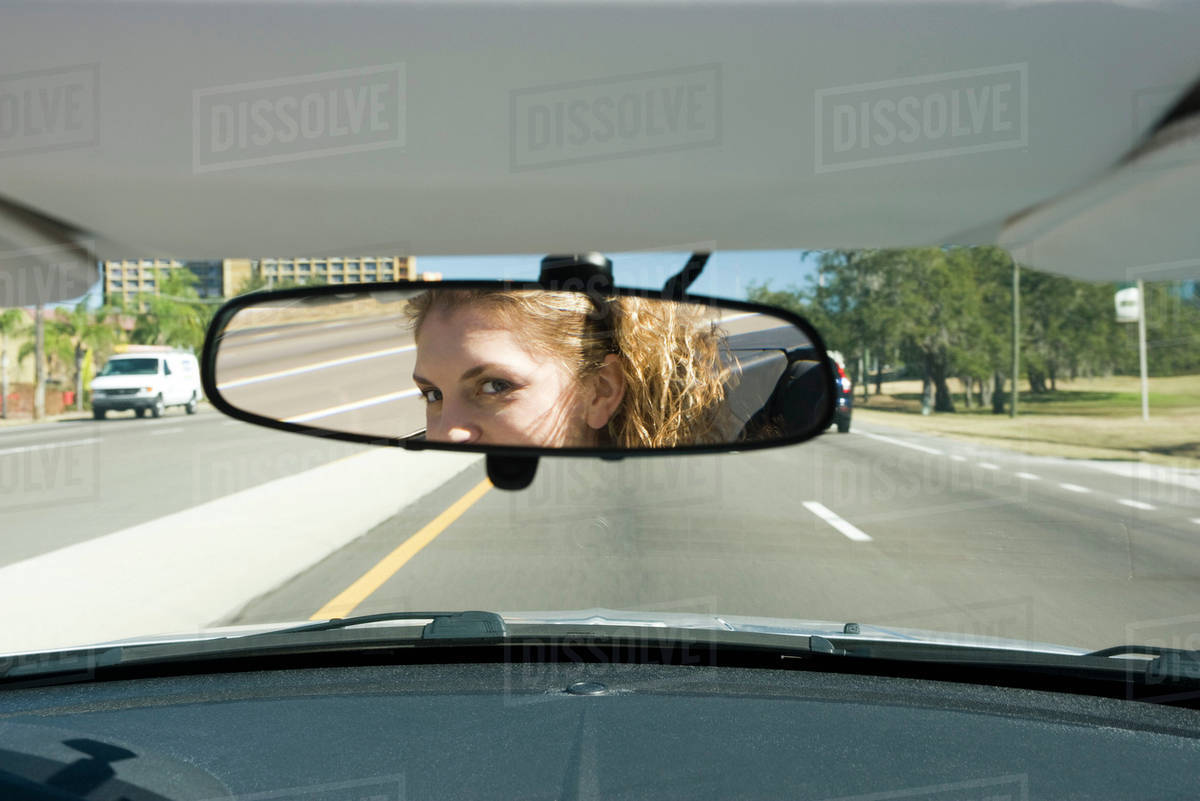 Woman driving, checking rear view mirror - Royalty-free Stock Photo ...