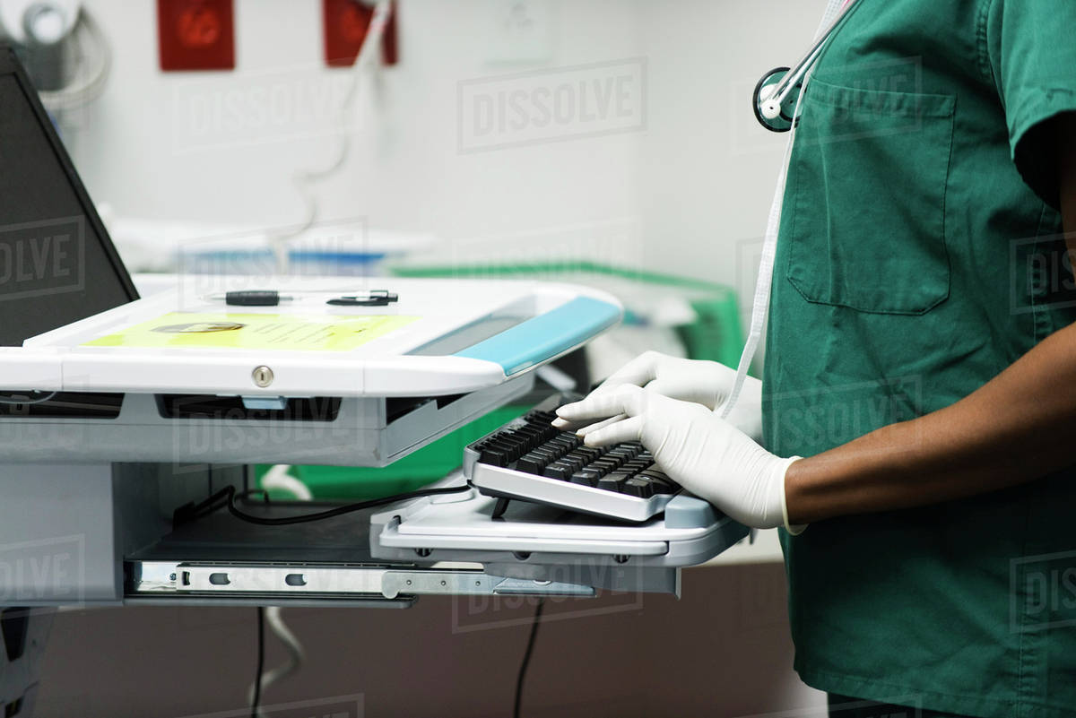 Healthcare worker using computer - Royalty-free Stock Photo | Dissolve