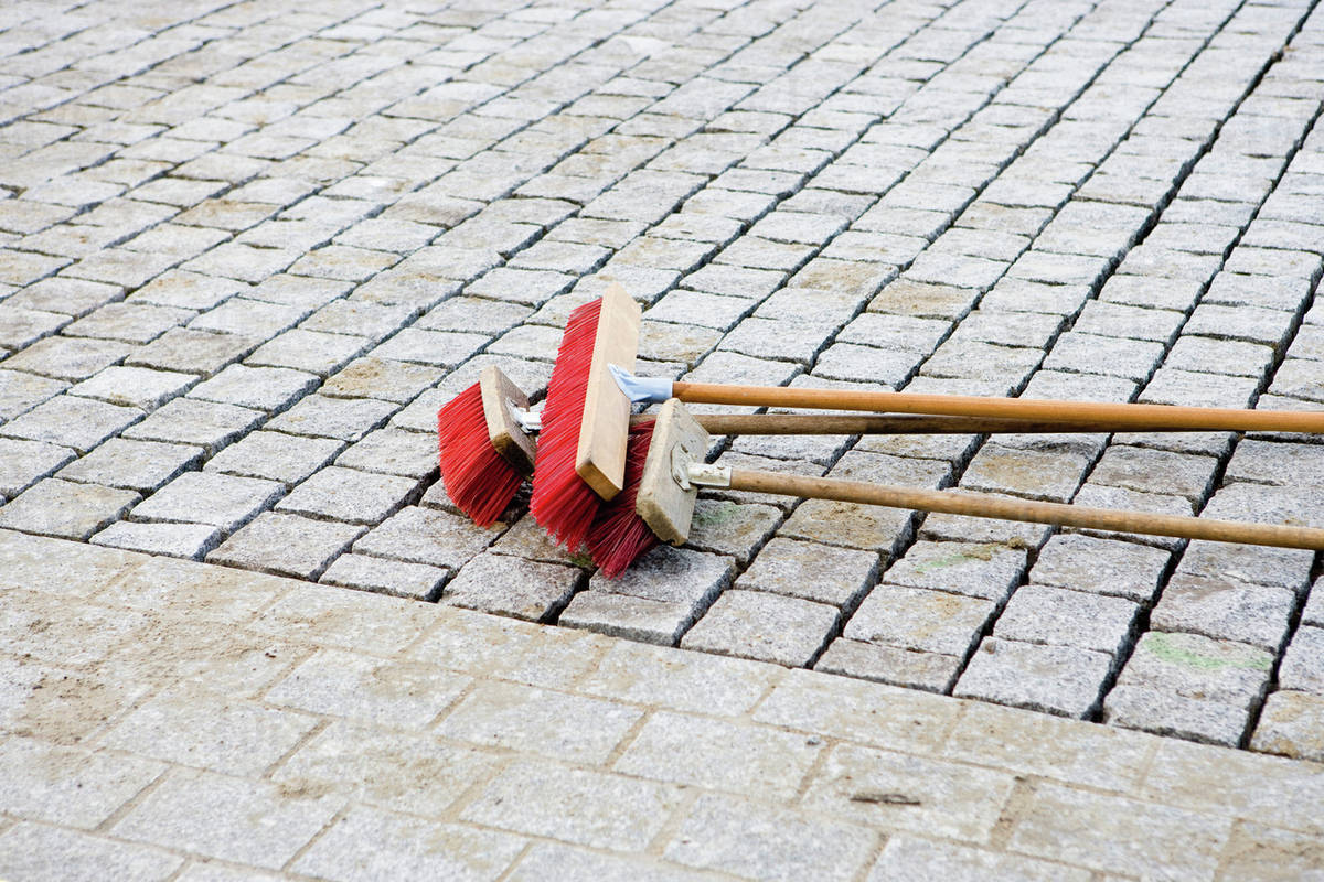Brooms on cobblestone street - Royalty-free Stock Photo | Dissolve