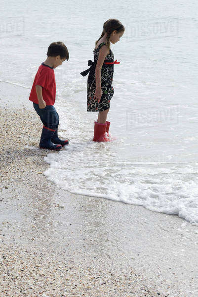 Children wading in surf at the beach - Royalty-free Stock Photo | Dissolve