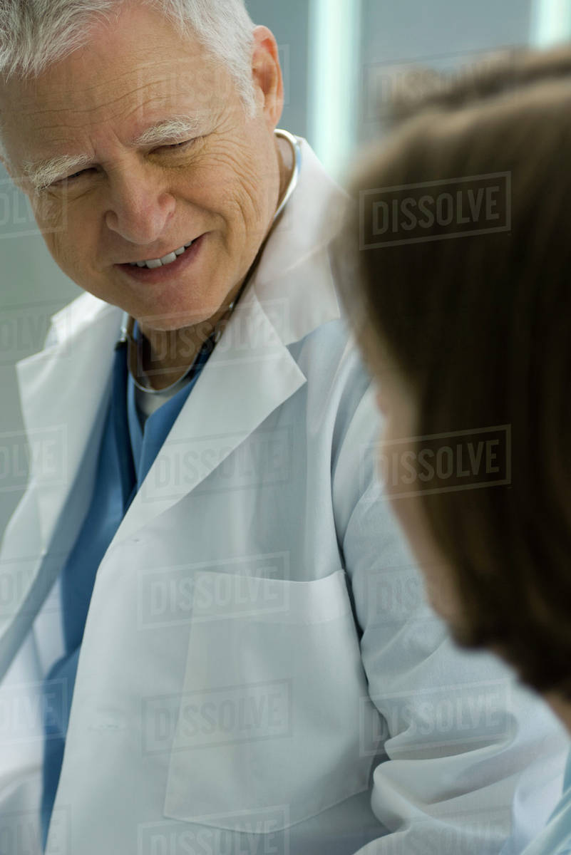 Doctor talking and smiling with patient - Royalty-free Stock Photo ...