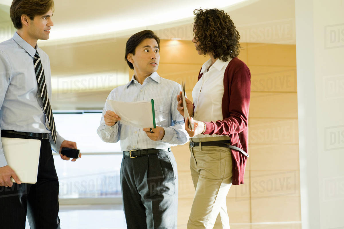 Executives talking in corridor - Royalty-free Stock Photo | Dissolve