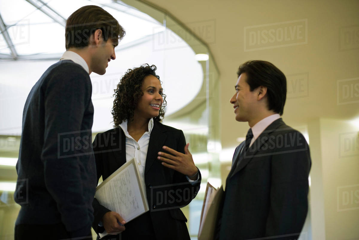 Executives talking in corridor - Royalty-free Stock Photo | Dissolve