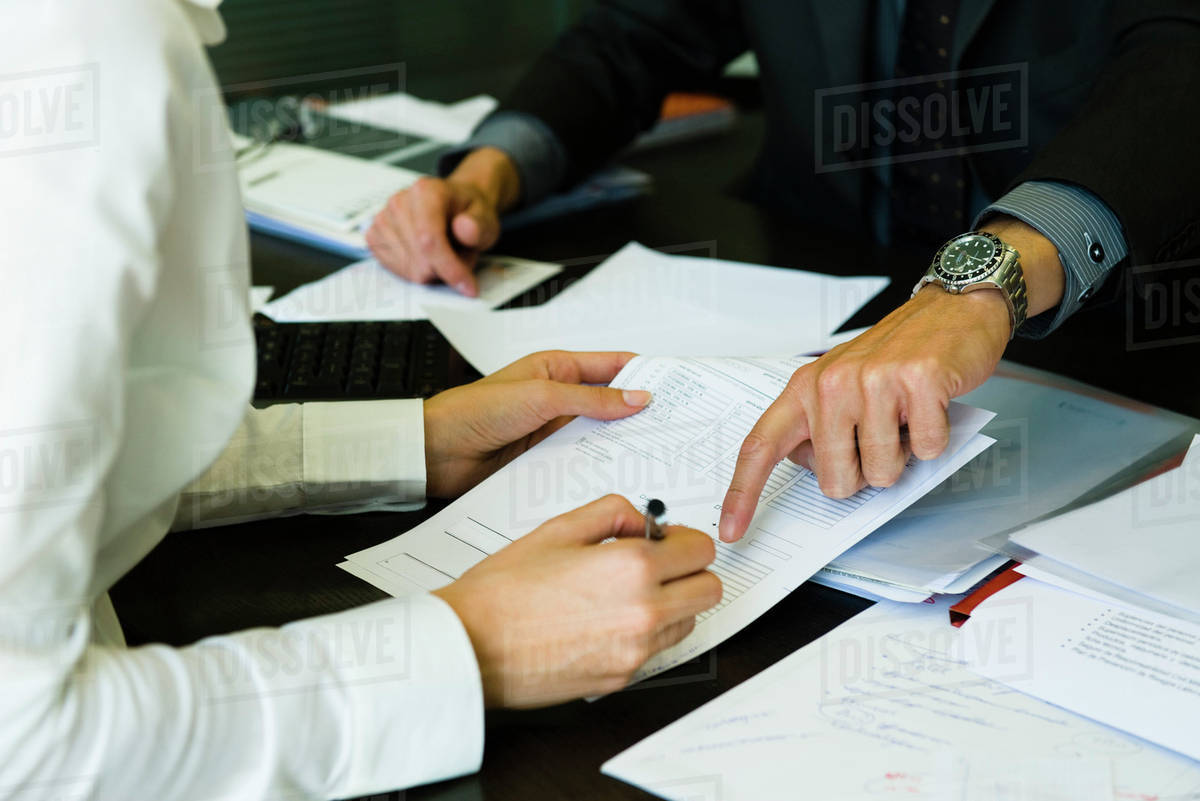 Person signing paperwork, cropped - Royalty-free Stock Photo | Dissolve
