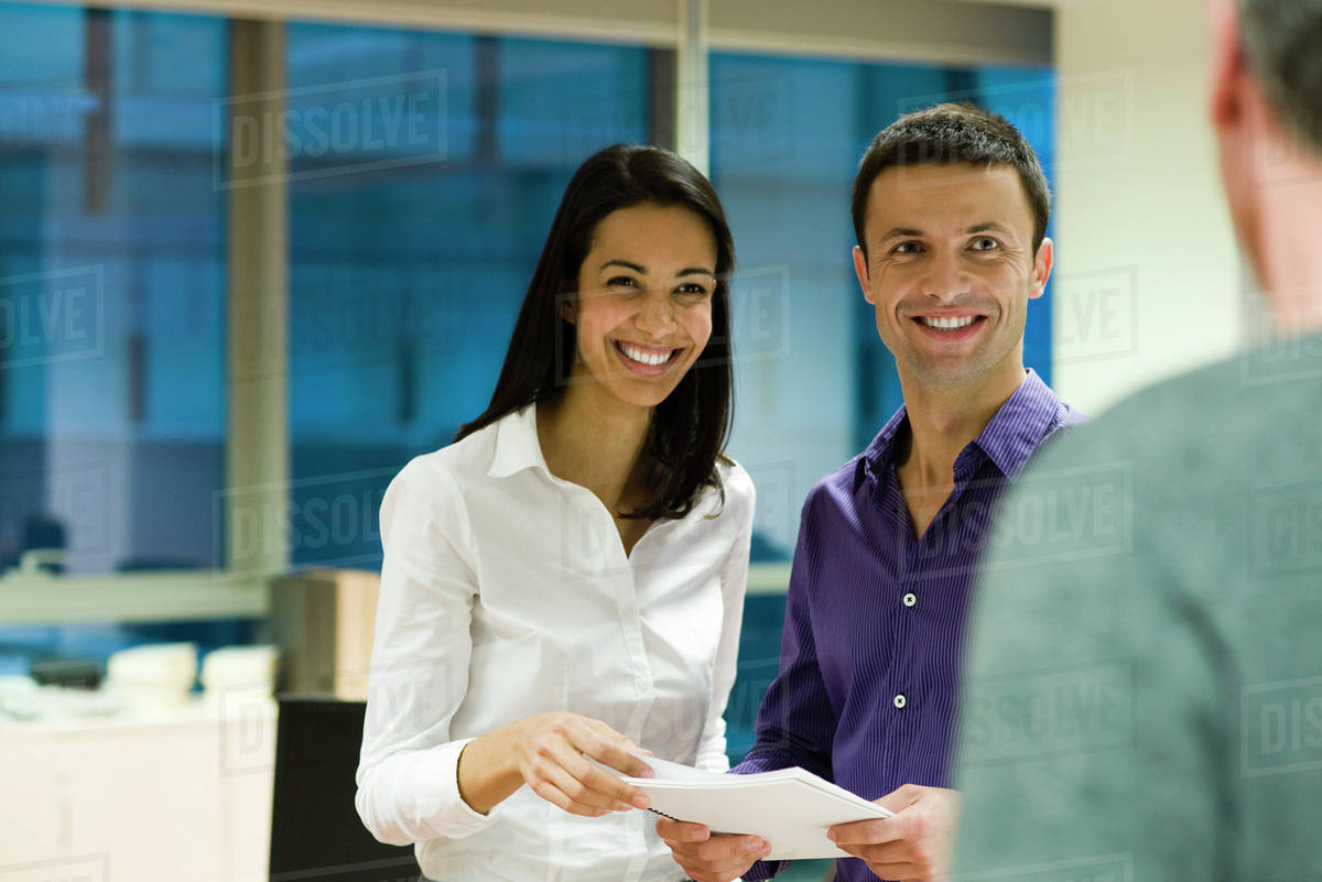 Colleagues laughing together in office - Stock Photo - Dissolve
