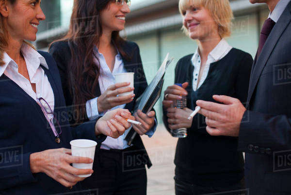 Colleagues taking smoking break outdoors - Royalty-free Stock Photo ...