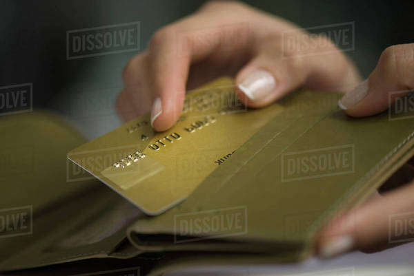 Woman's hand taking credit card out of wallet - Royalty-free Stock ...