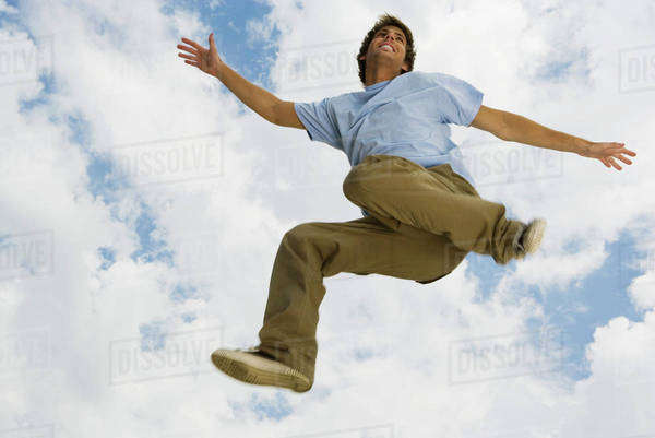 Young man jumping in midair, low angle view - Royalty-free Stock Photo ...