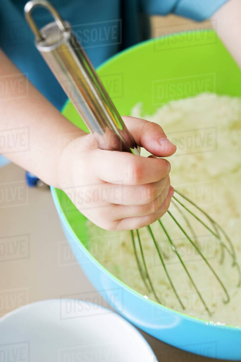 Child stirring batter with whisk, cropped view - Royalty-free Stock ...