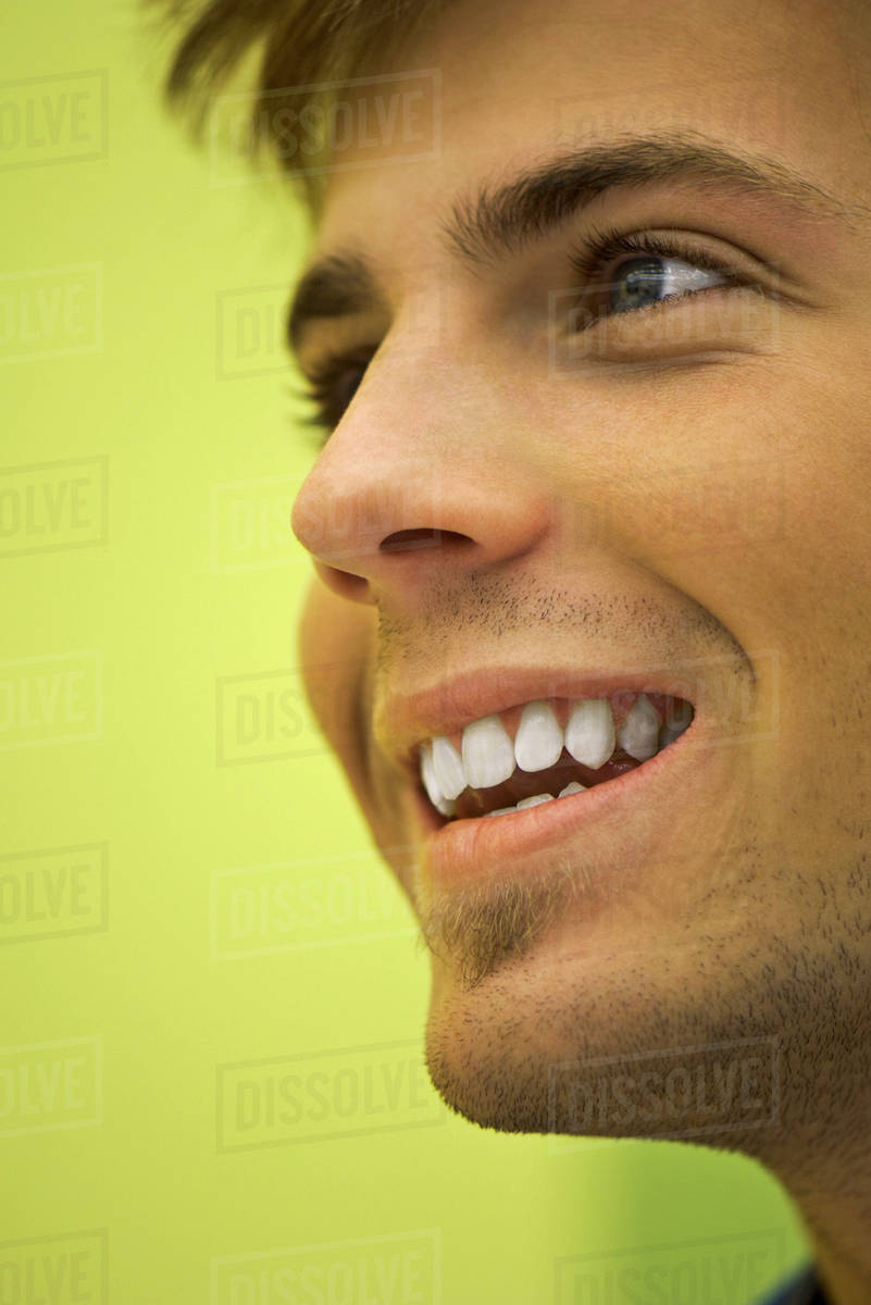 Young man smiling, portrait - Royalty-free Stock Photo | Dissolve