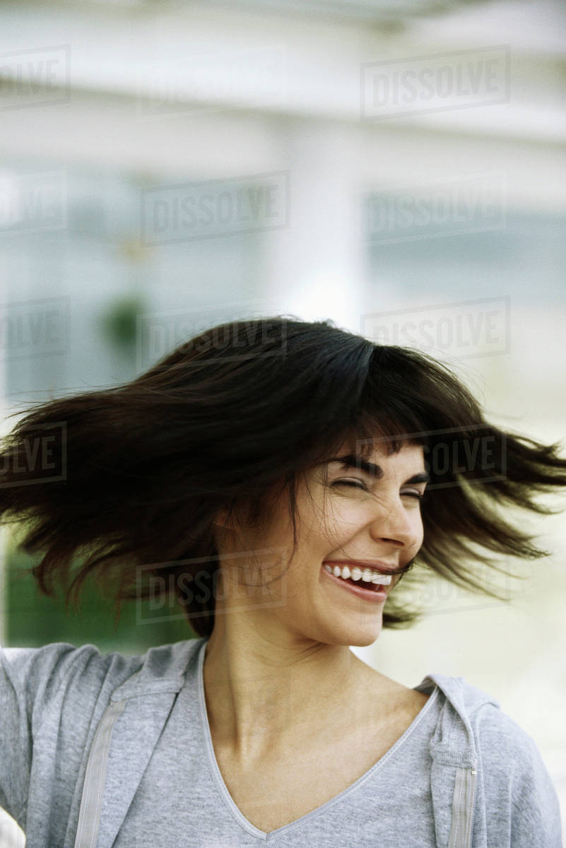 Woman tossing hair, portrait - Stock Photo - Dissolve