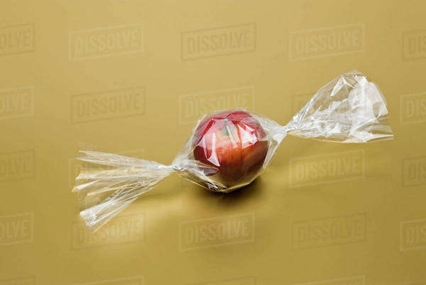 Food concept, fresh apple inside cellophane candy wrapper - Royalty ...