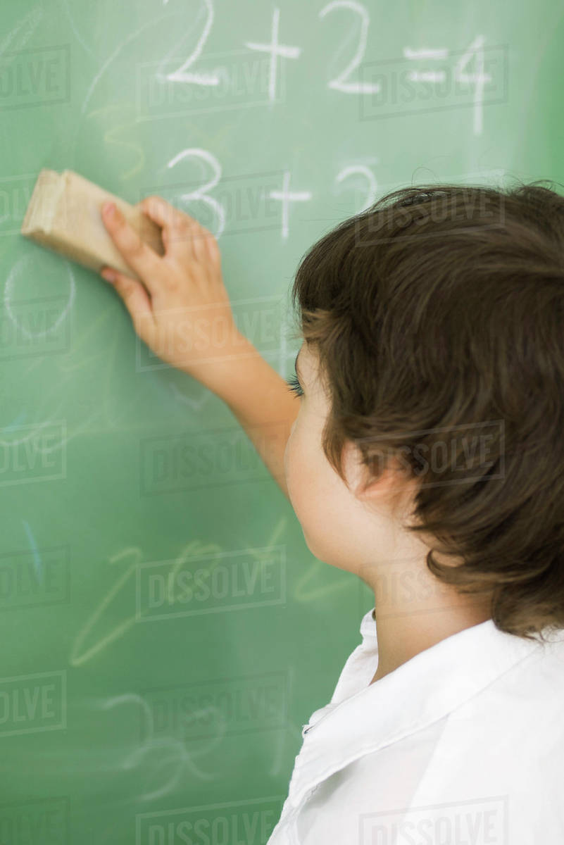 Boy erasing blackboard - Royalty-free Stock Photo | Dissolve