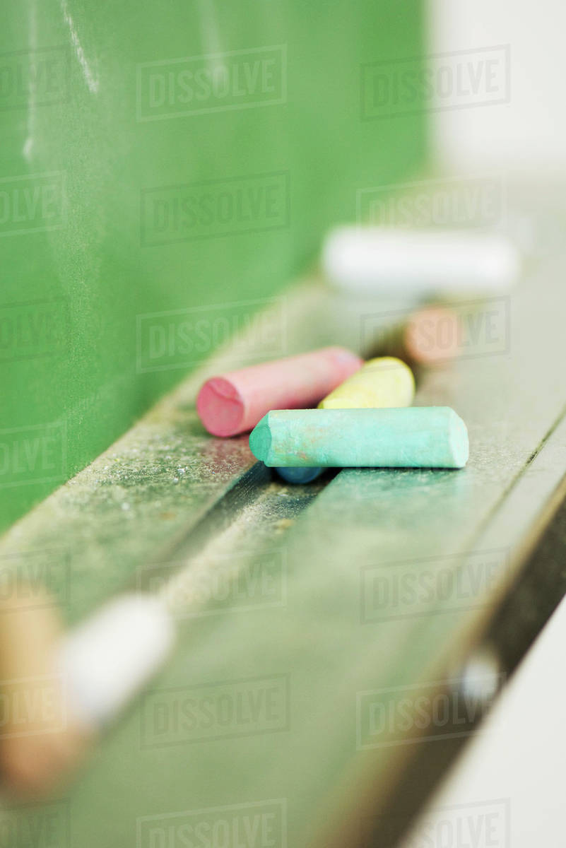 Chalk resting on blackboard, close-up - Royalty-free Stock Photo | Dissolve
