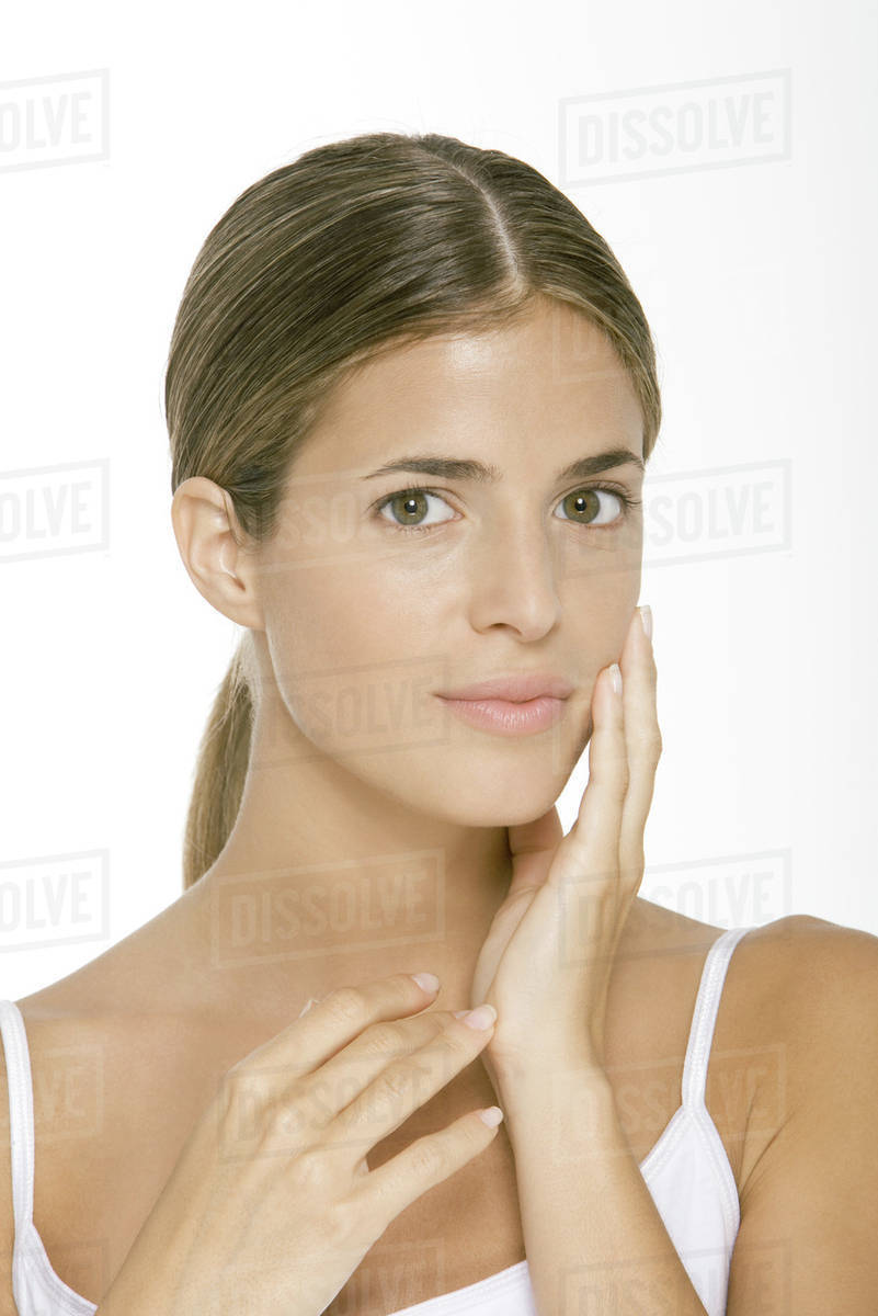 Woman touching cheek, smiling at camera, portrait - Royalty-free Stock ...