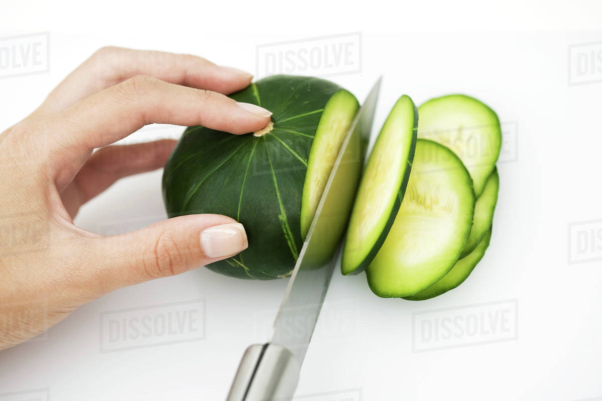 Woman slicing squash with knife, cropped view of hand - Royalty-free ...