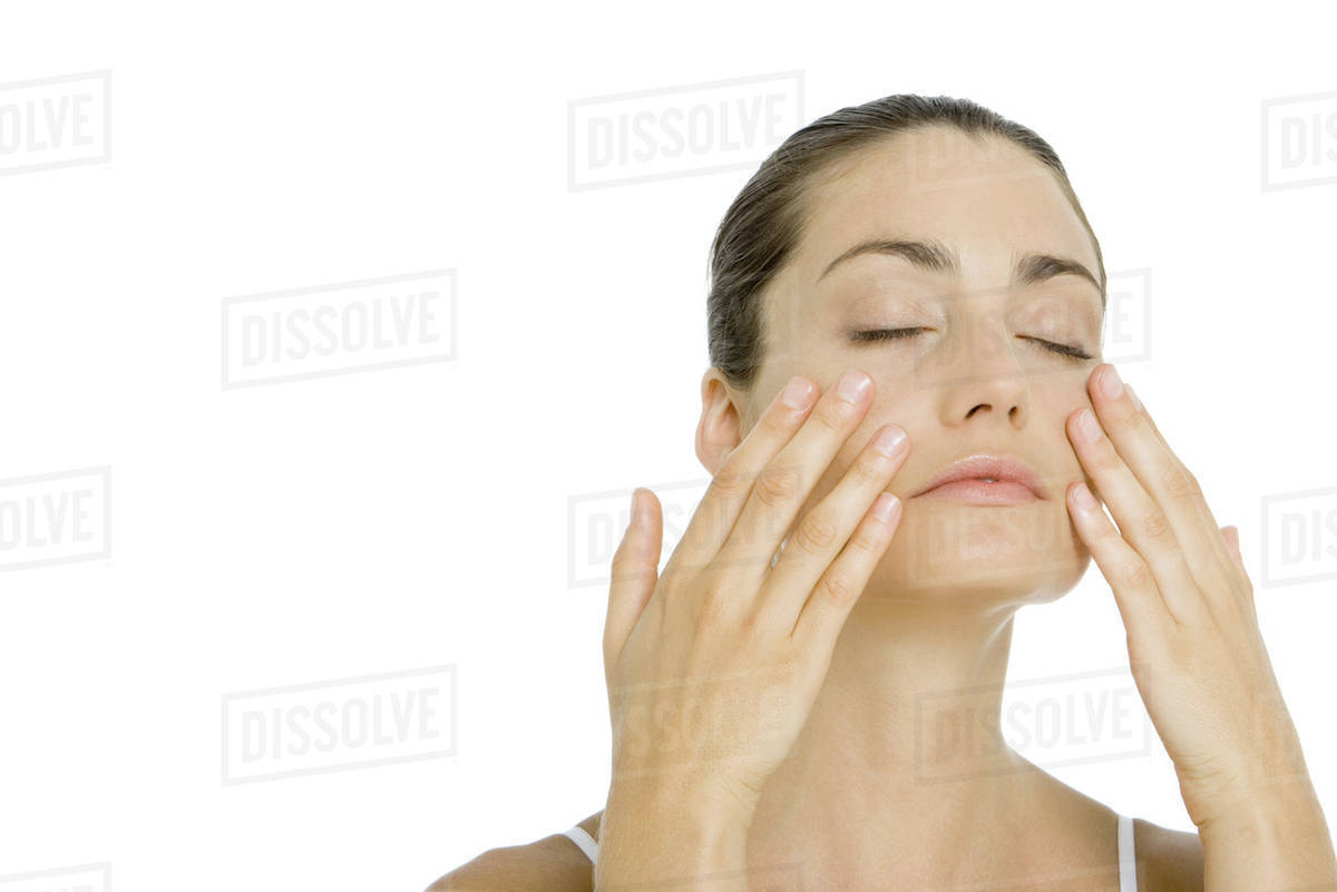 Woman touching face with both hands, eyes closed - Royalty-free Stock ...