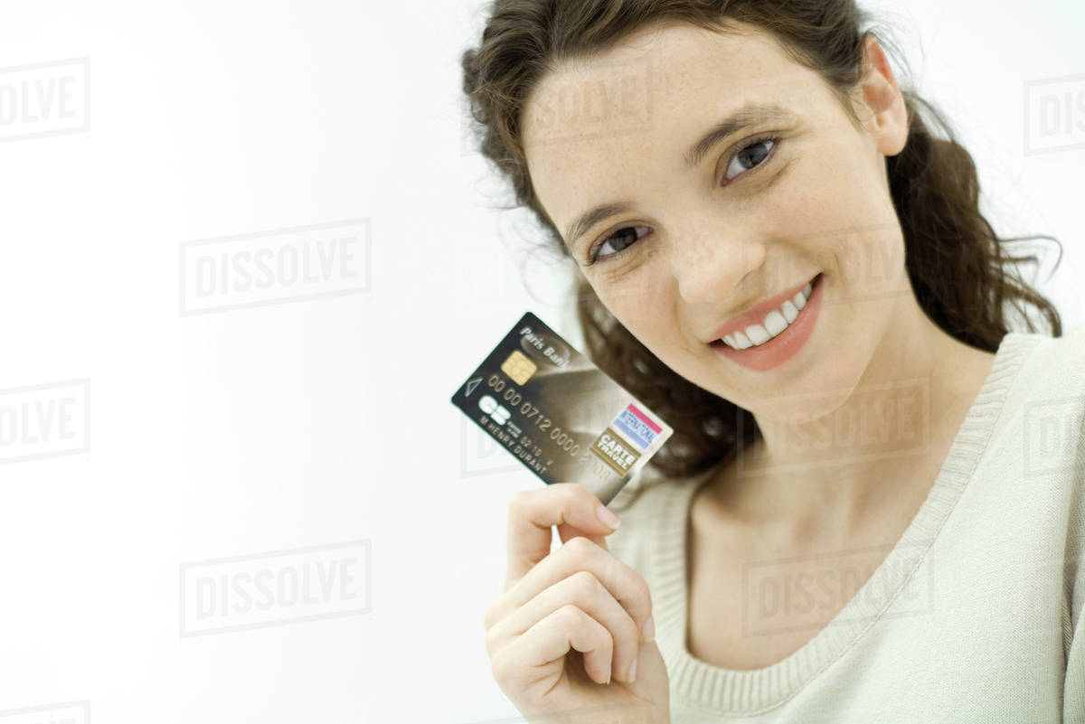 Woman holding credit card, smiling at camera - Royalty-free Stock Photo ...