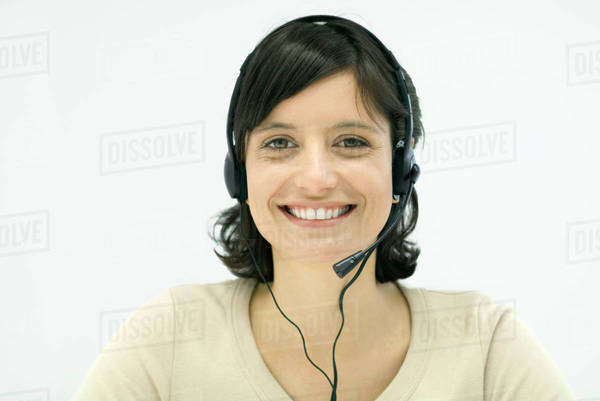 Woman wearing headset, smiling at camera, portrait - Royalty-free Stock ...