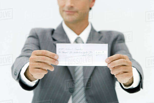Businessman holding out check, cropped view - Royalty-free Stock Photo ...