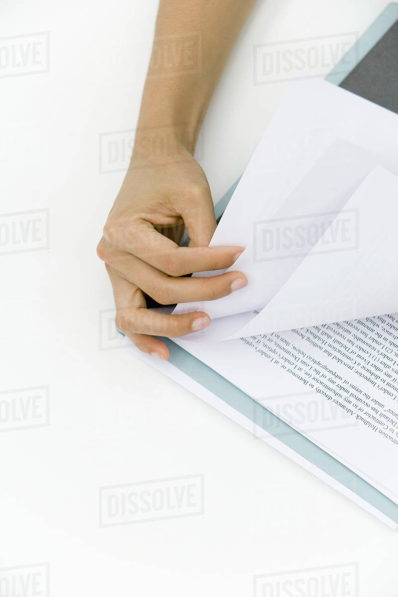 Hand turning document pages, close-up - Royalty-free Stock Photo | Dissolve