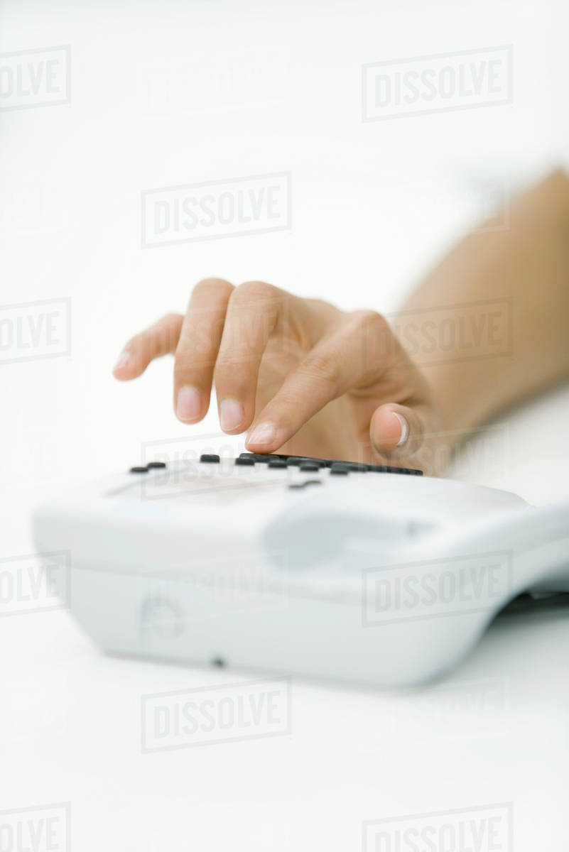 Hand dialing landline phone, cropped view - Royalty-free Stock Photo ...