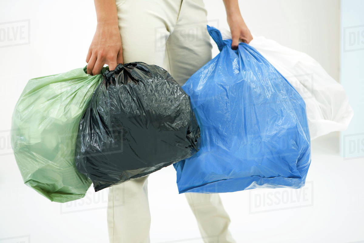 Female carrying several bags of garbage, cropped view - Royalty-free ...