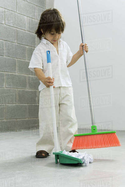 Little boy sweeping the floor - Stock Photo - Dissolve
