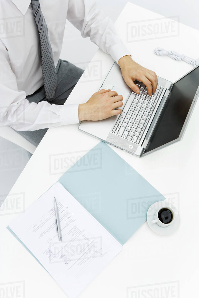 Man using laptop on desk, high angle cropped view - Royalty-free Stock ...