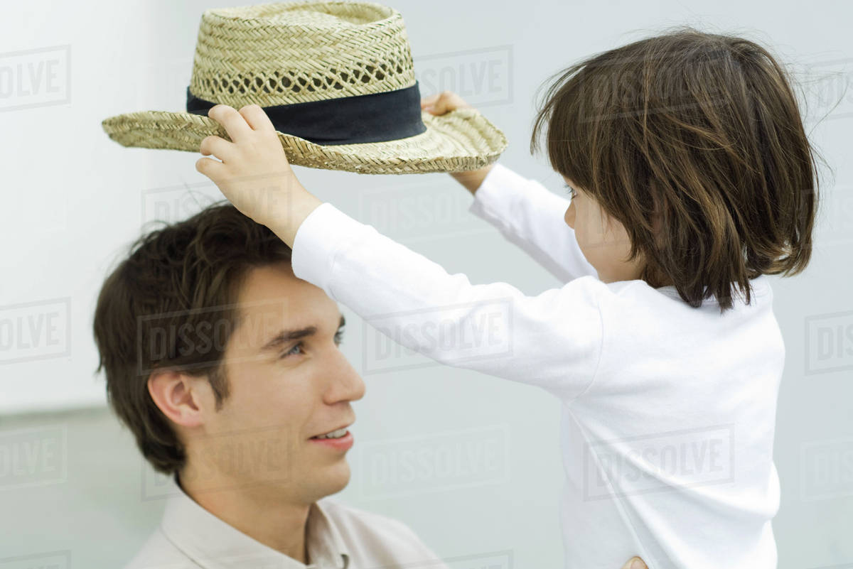 Little boy picking hat up off his father's head - Royalty-free Stock ...