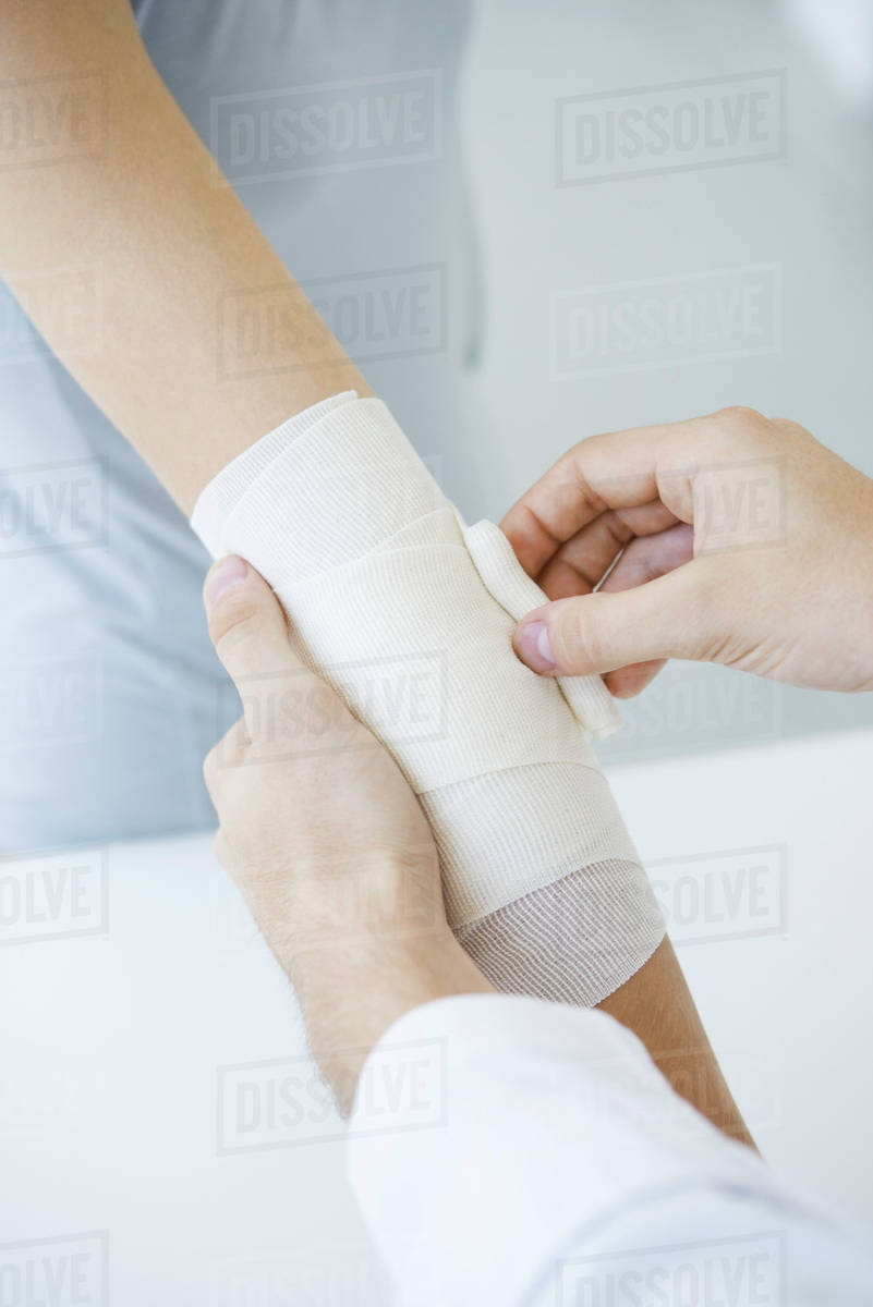 Doctor bandaging patient's arm, cropped view - Royalty-free Stock Photo ...