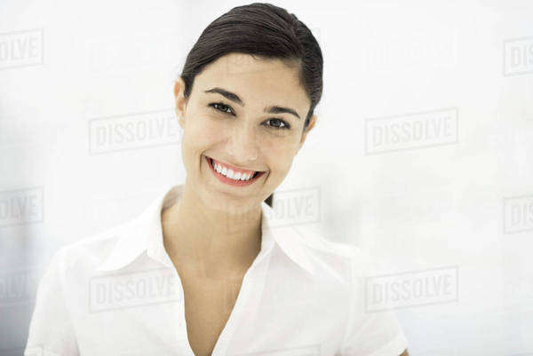 Woman smiling at camera, portrait - Royalty-free Stock Photo | Dissolve